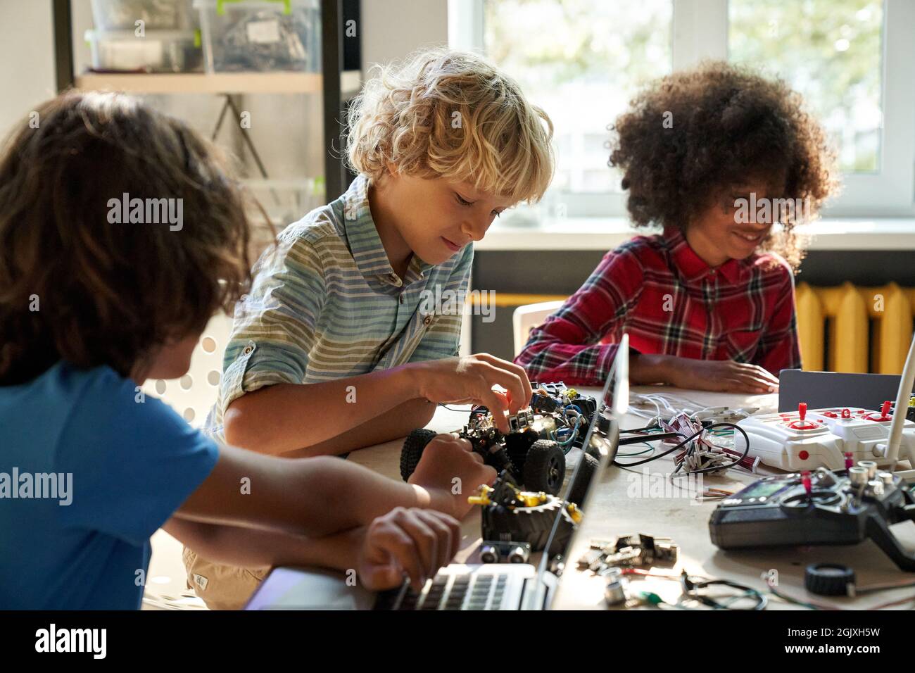 Diverse schoolkids building robotic technologies at STEM educational ...