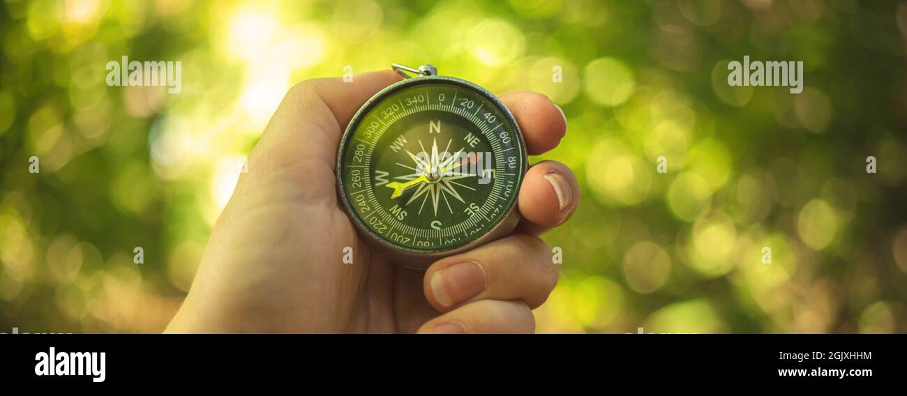 Orienteering in the woods with compass in the hand, banner Stock Photo ...
