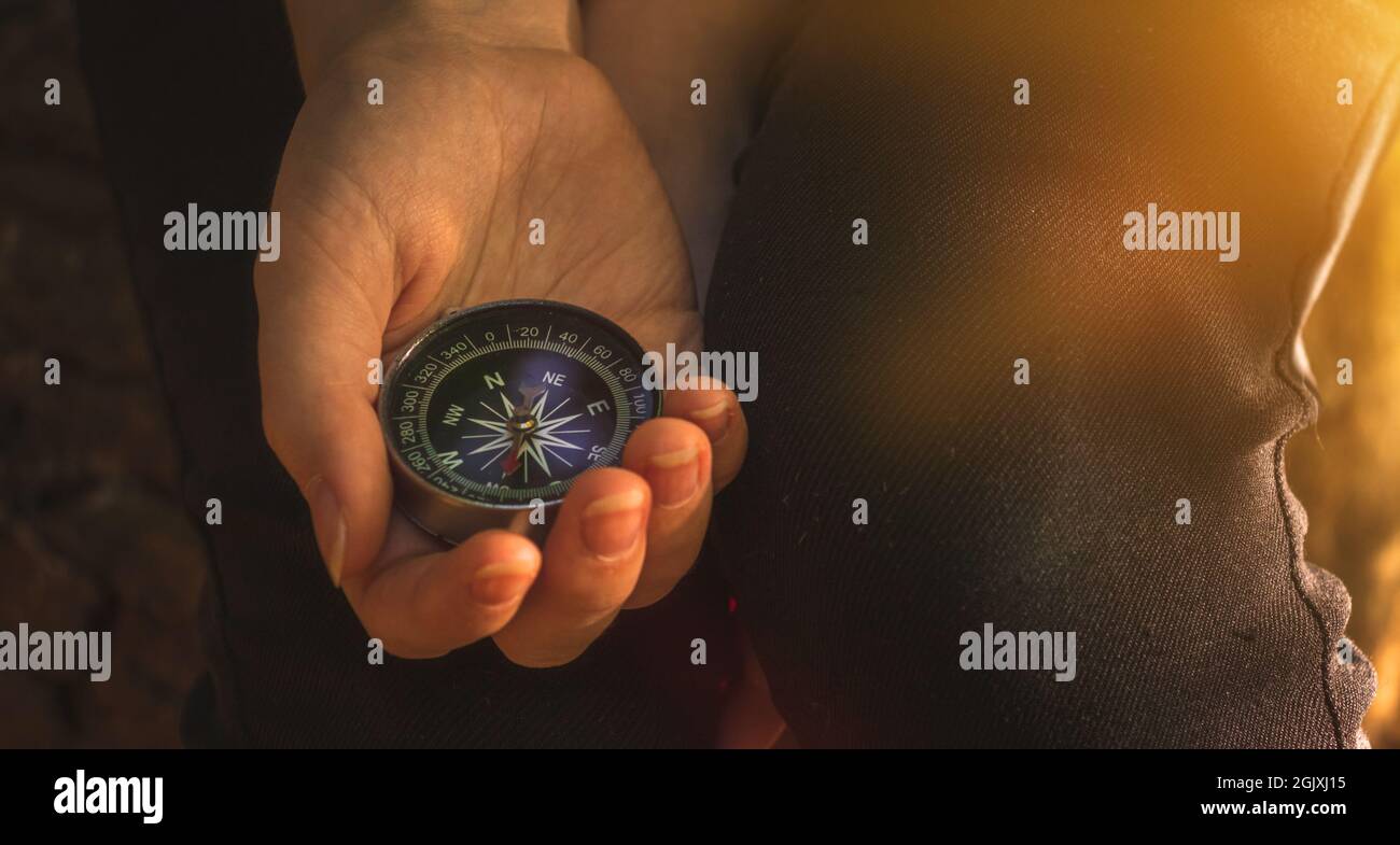 Traveler using compass in the woods, stock photo Stock Photo - Alamy