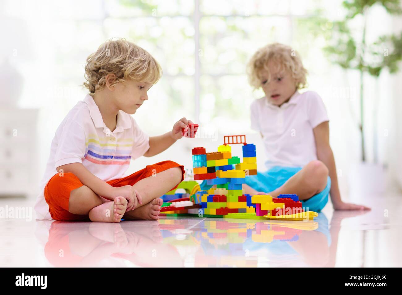 Child playing with colorful toy blocks. Kids play with plastic bricks ...
