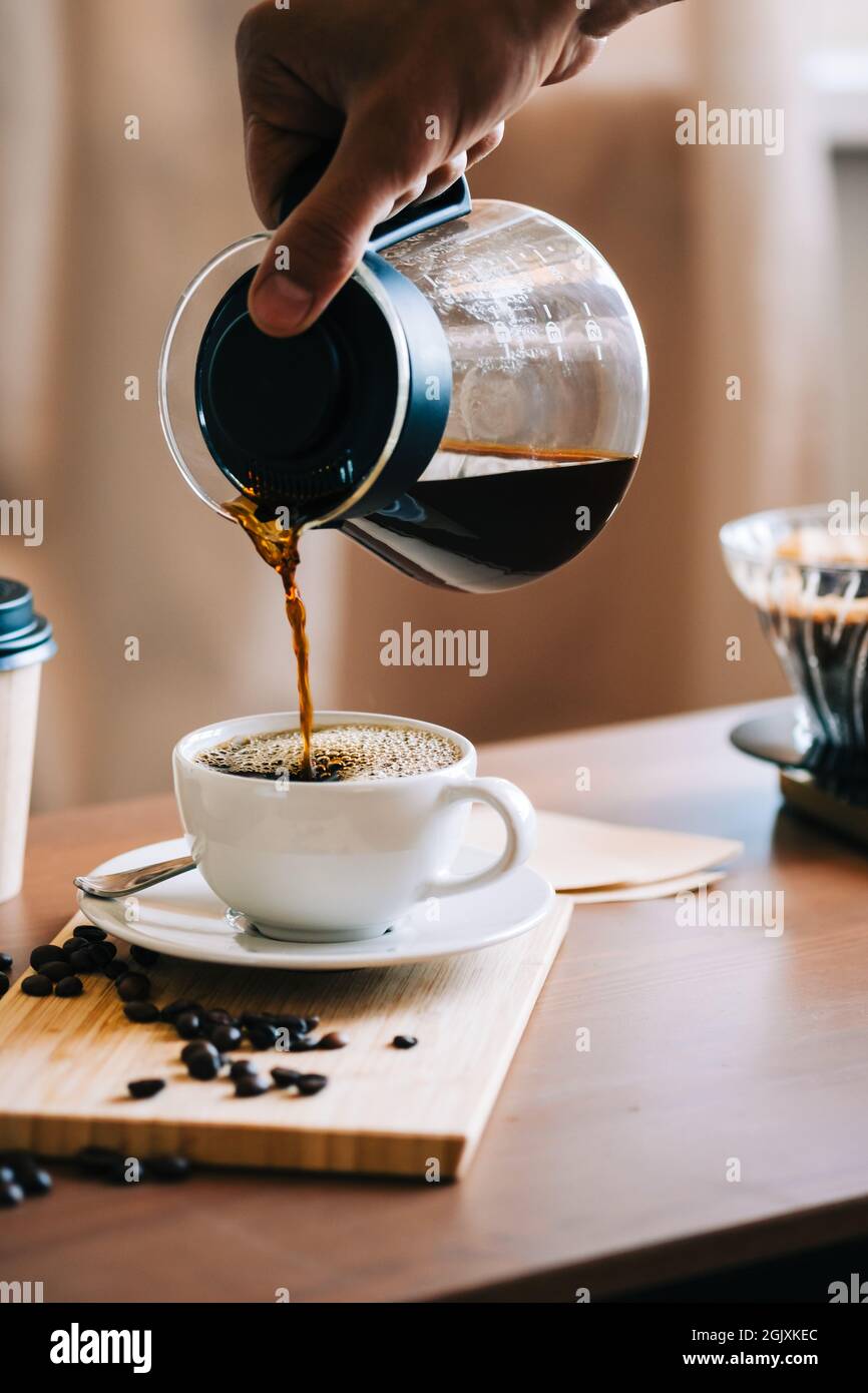 Man pouring coffee in a cup, alternative coffee brewing method, using ...