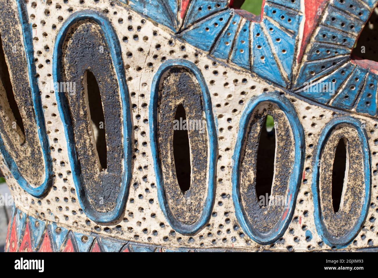 Clay surface with abstract ethnic pattern and holes. Abstract ...