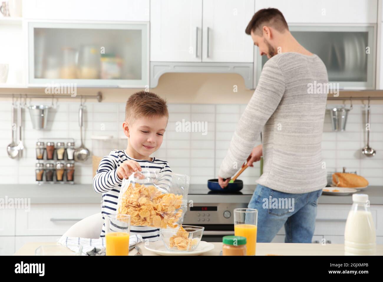 Dad and son preparing to have lunch at home Stock Photo - Alamy