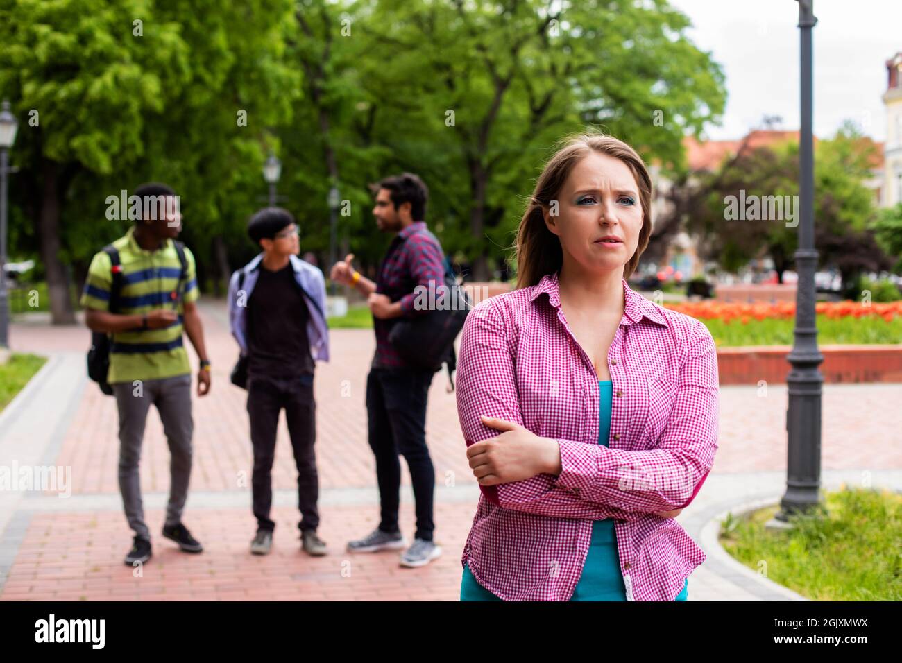 Portrait of lonely college student girl standing at the campuspark ...