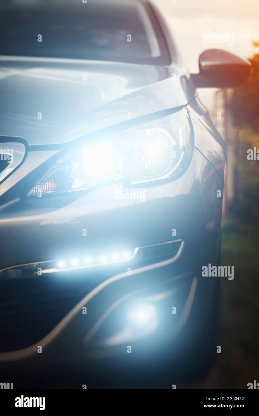 Car front view with glowing headlights Stock Photo - Alamy