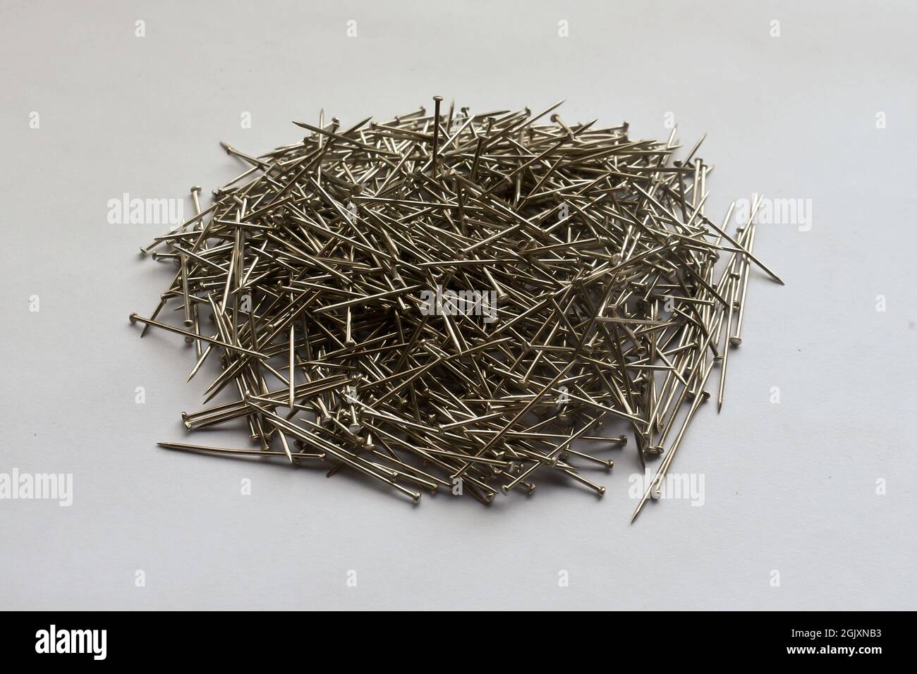 shiny silver sewing pins on a white studio background Stock Photo - Alamy