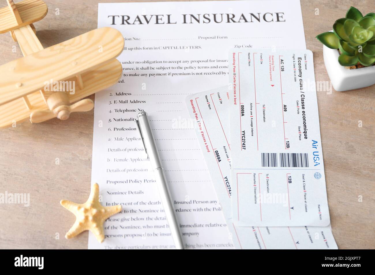 Tickets and pen on travel insurance form Stock Photo - Alamy