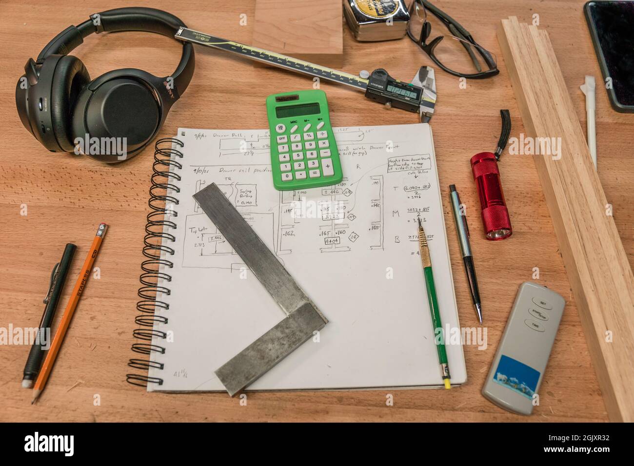 Flat lay of woodworking planning implements including sketchpad ...