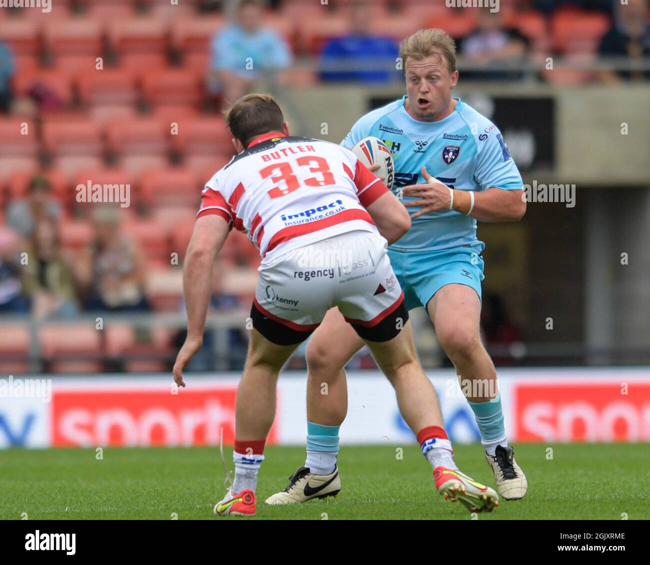 Eddie Battye (15) of Wakefield Trinity looks for a way past Rob Butler ...