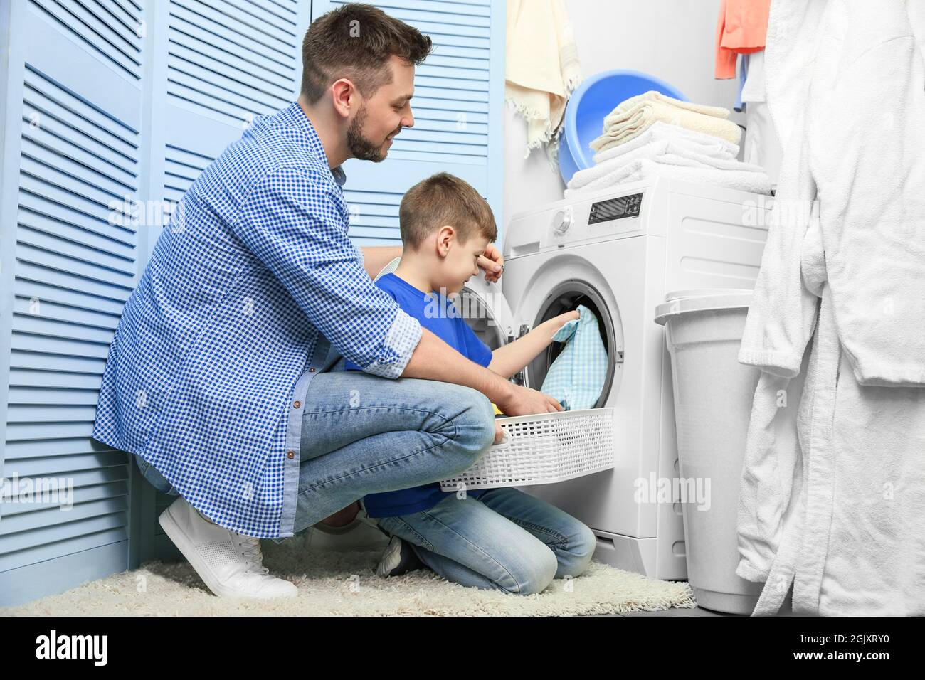Dad and son doing laundry at home Stock Photo - Alamy