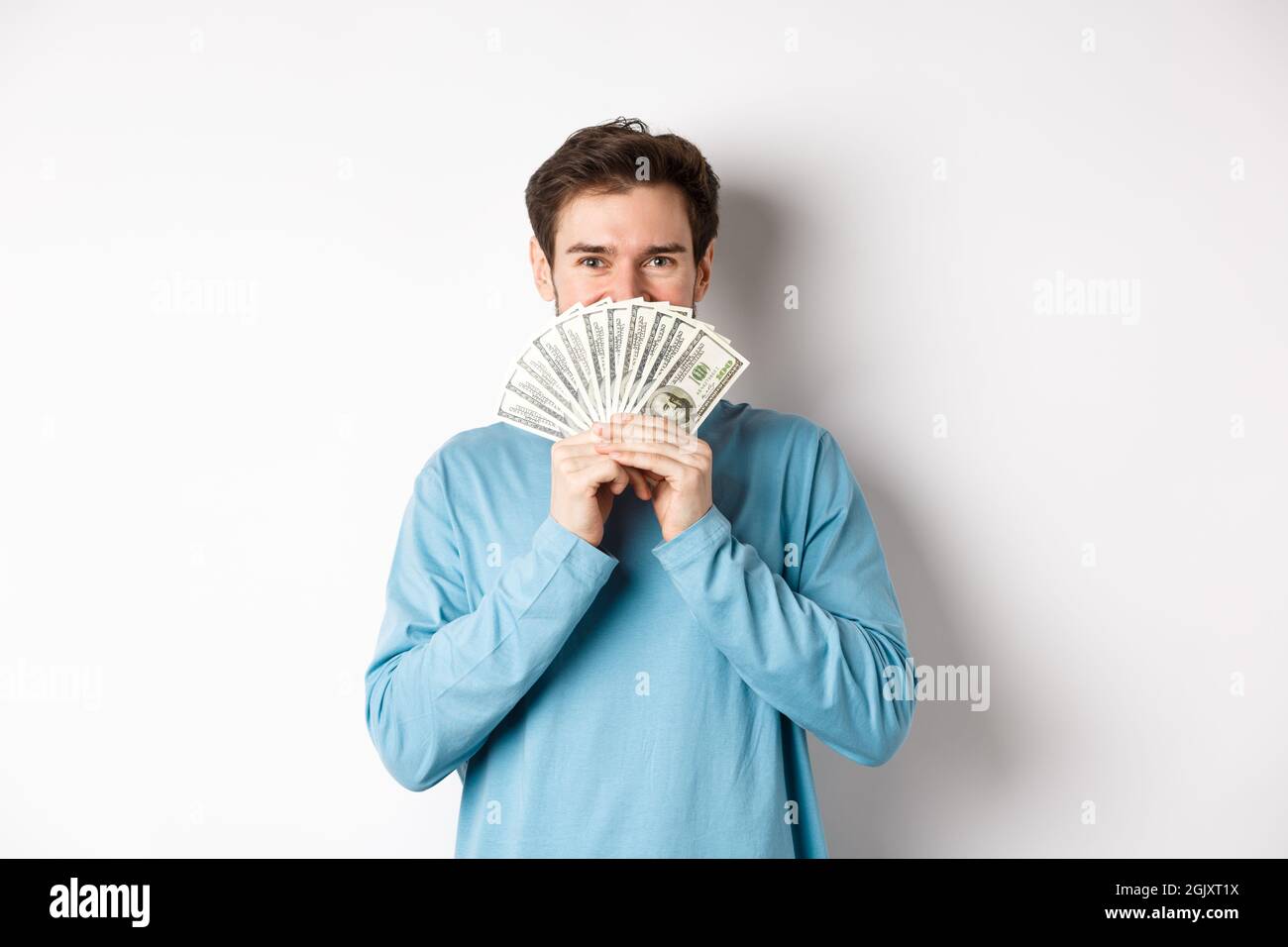 Cheerful shopper holding money for shopping, standing with dollars and ...