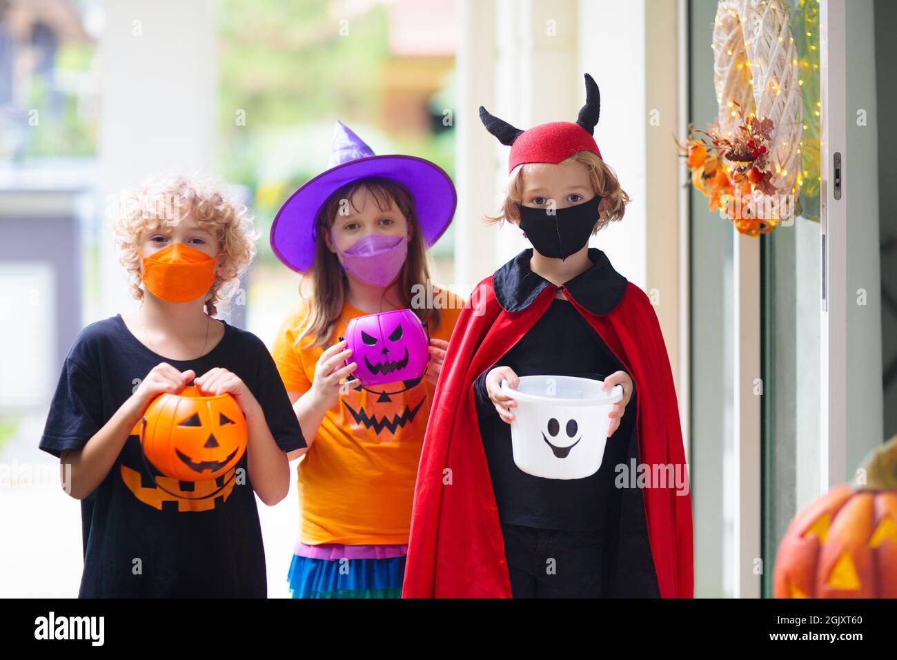 Kids trick or treat in Halloween costume and face mask. Children in ...