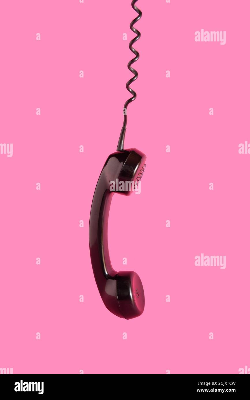 Creative concept of communication. Handset with cable. Pink background ...