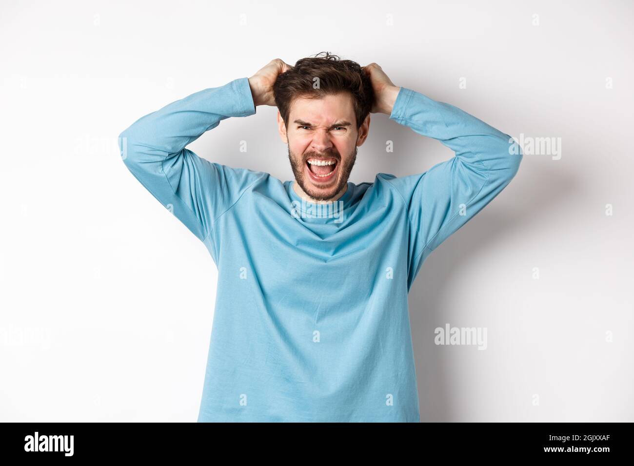 Mad young man pull hair oyt of head and screaming angry, shouting ...