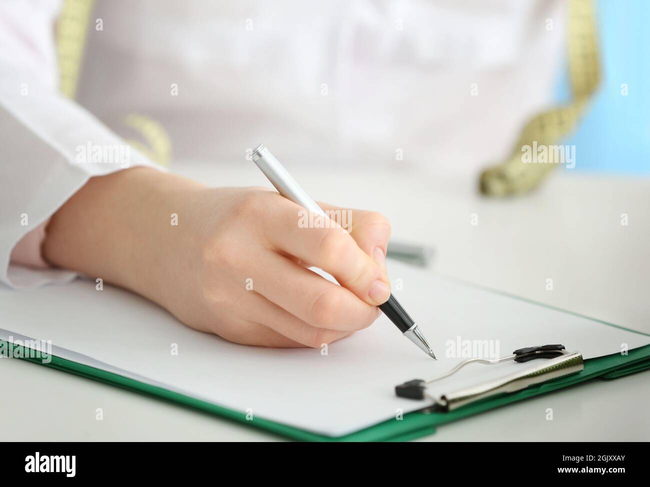 Young female nutritionist writing diet plan, closeup Stock Photo - Alamy