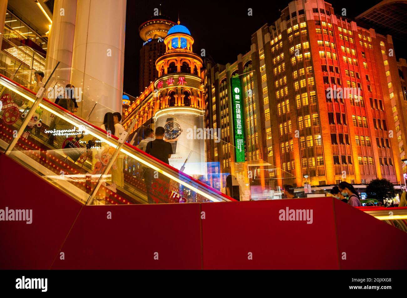 Shoppers going up the escalator at the Shimao building on Nanjing East ...