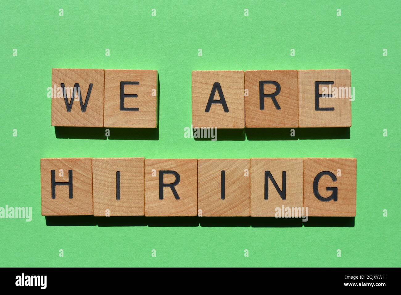 We Are Hiring, words in wooden alphabet letters isolated on green ...