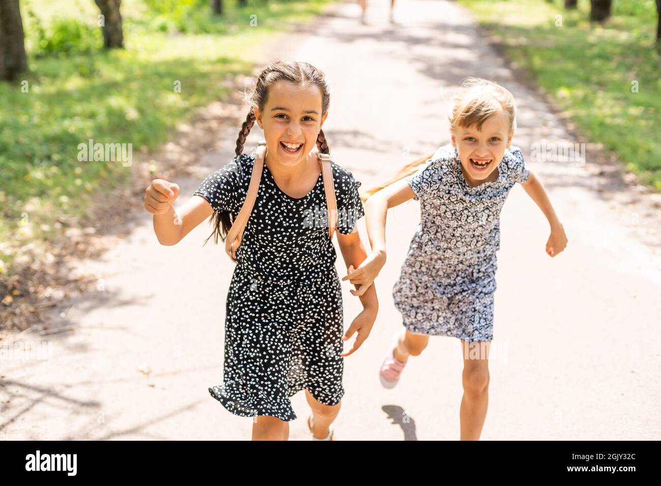 Two little kids going to school together Stock Photo - Alamy
