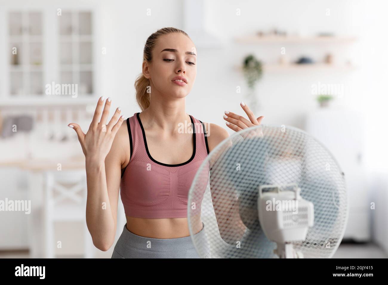 Woman cooling down fan hi-res stock photography and images - Alamy