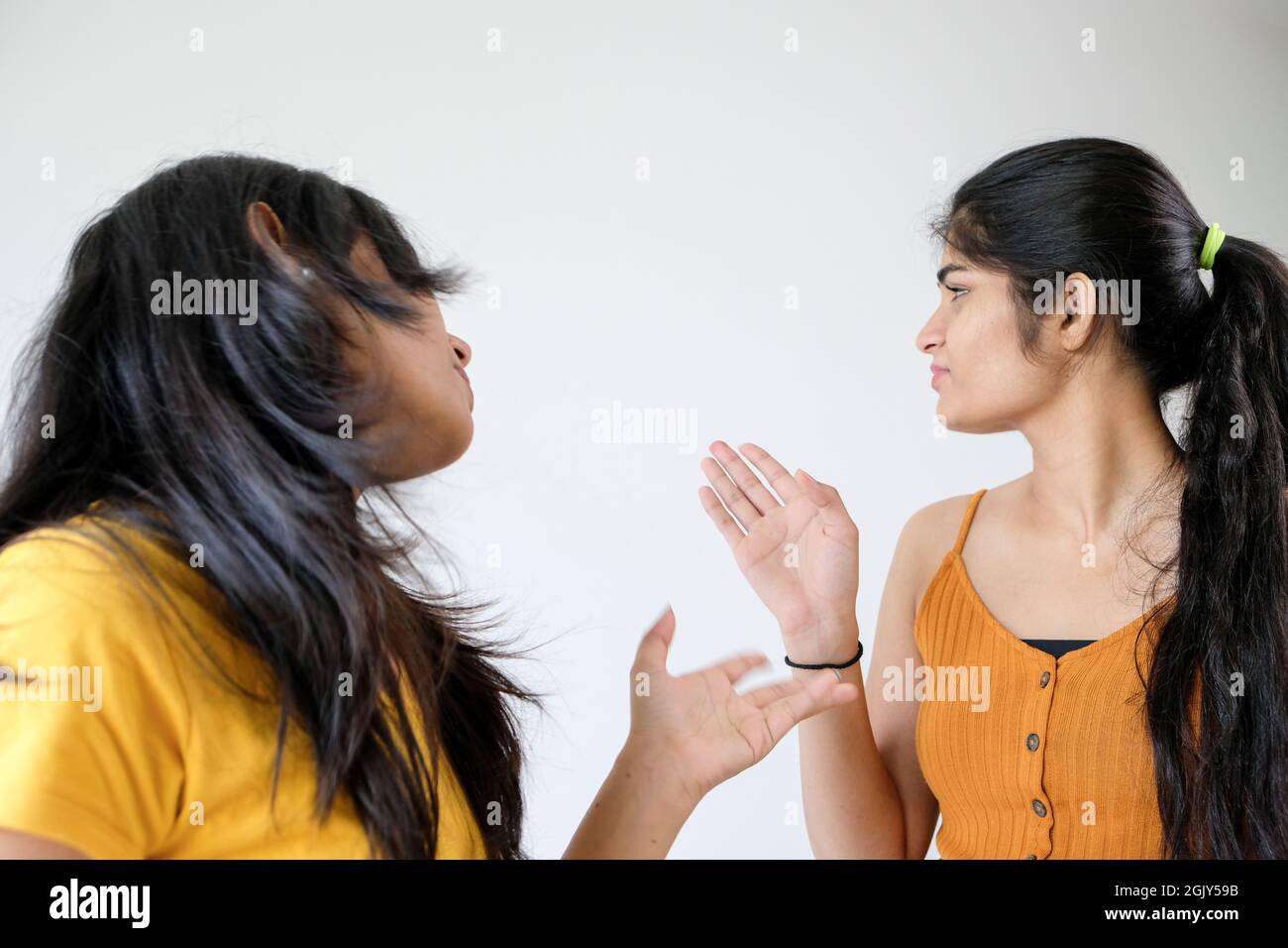 Two angry Indian friends having an argument on a white background Stock ...