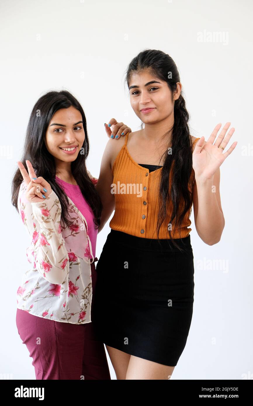 Two Indian best friends happily posing on a white background Stock ...