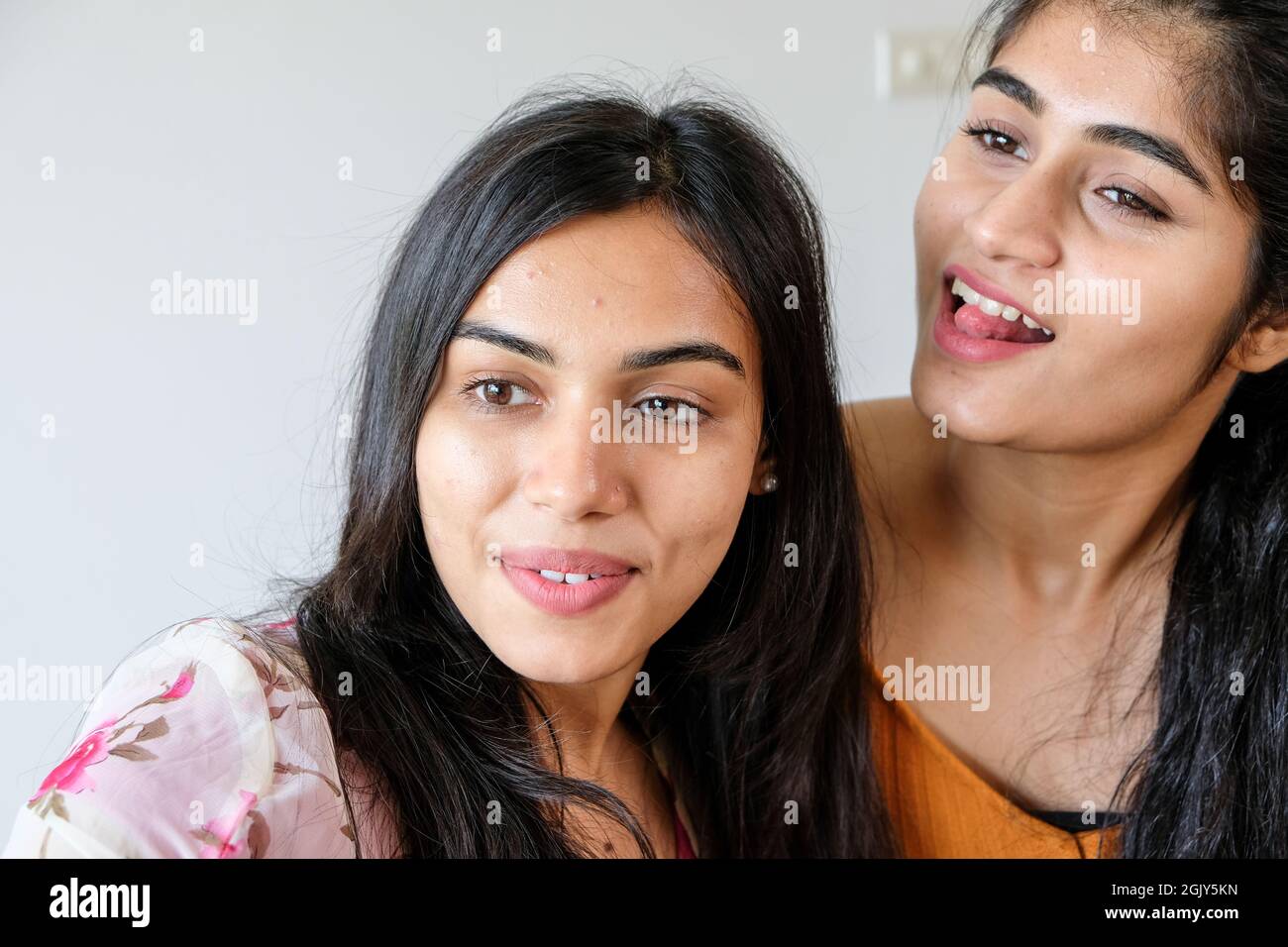 Two Indian best friends happily taking a selfie at home Stock Photo - Alamy