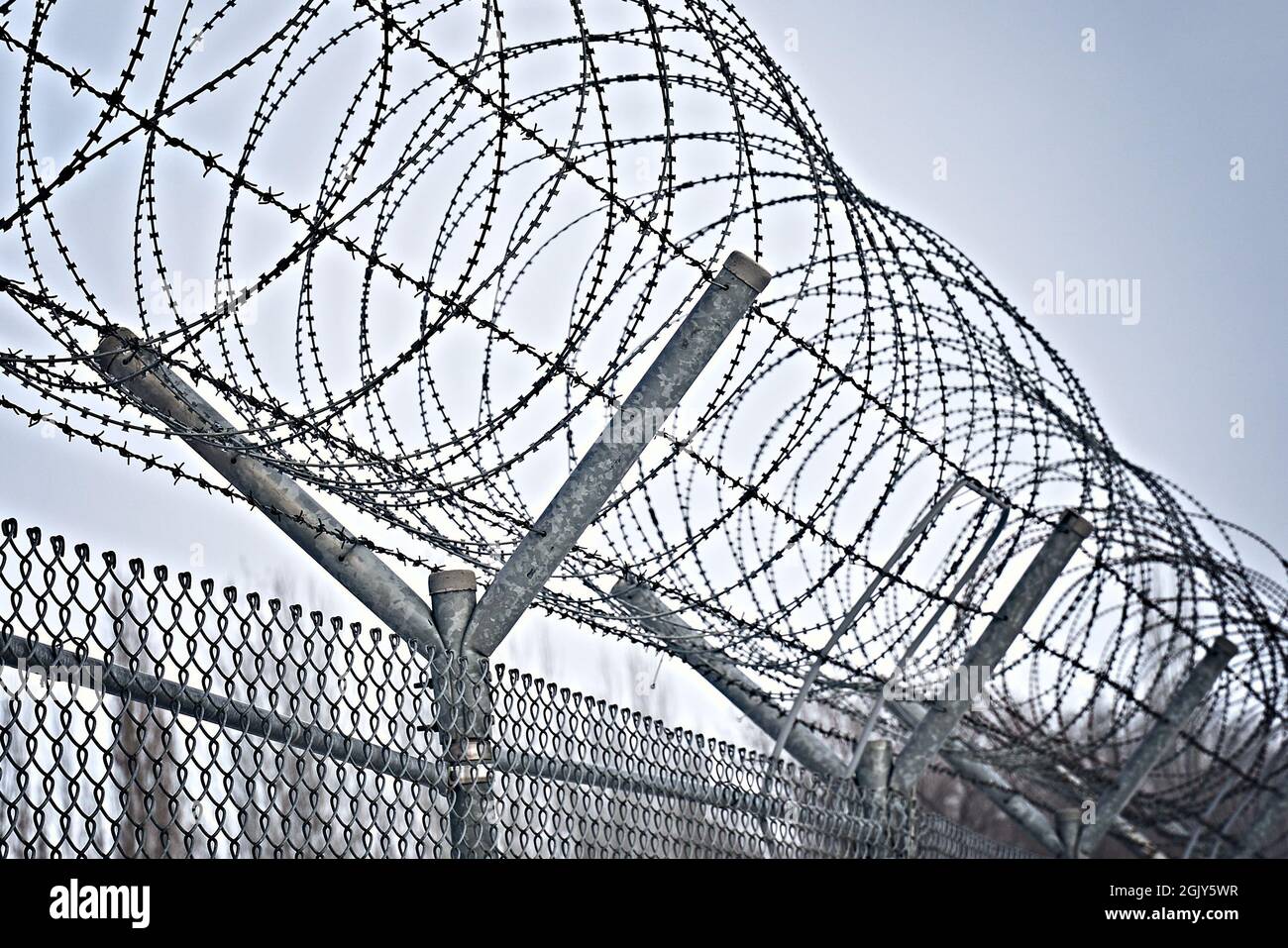 Prison fence. Barbed wire security fence. Razor wire jail fence ...