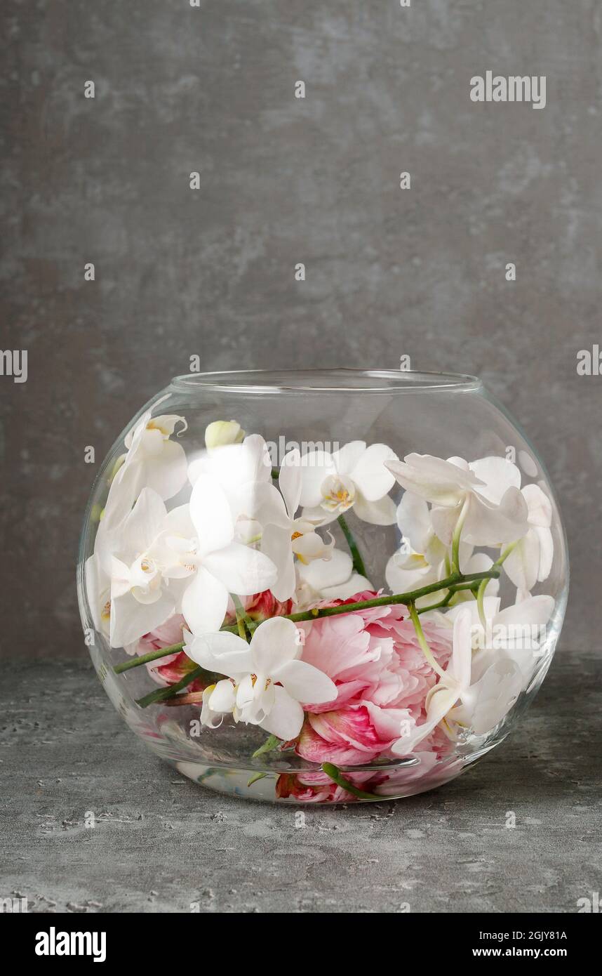 Glass sphere with floral arrangement inside. Home decor Stock Photo - Alamy