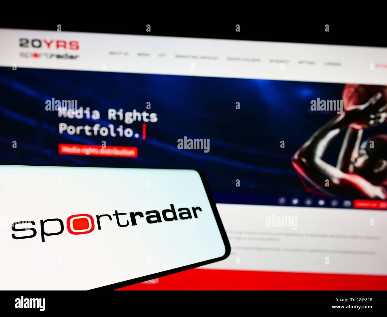 Mobile phone with logo of Swiss sports data company Sportradar AG on ...