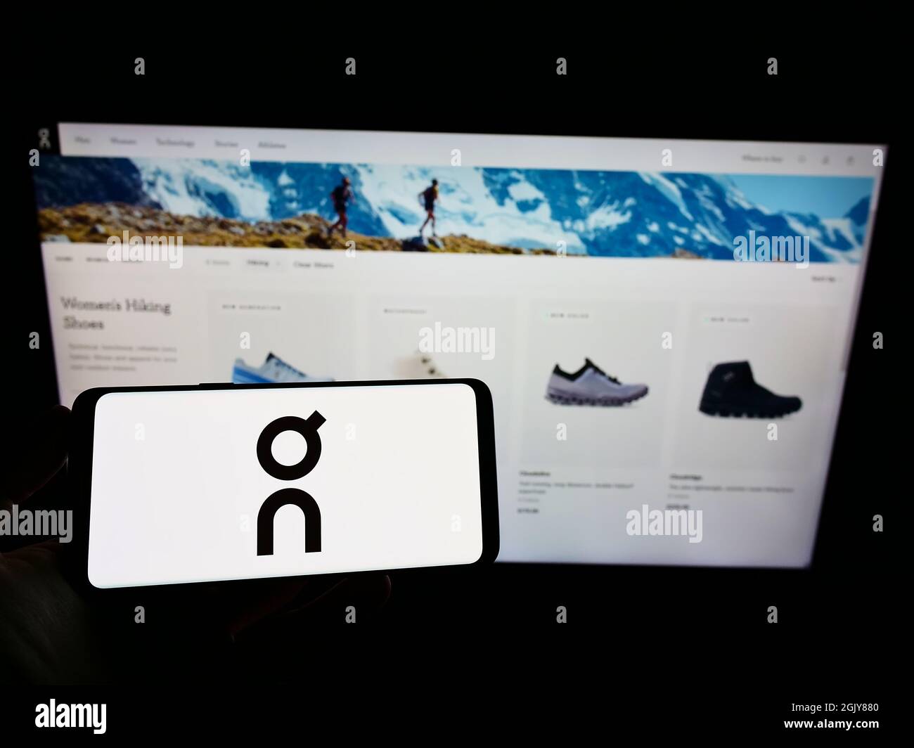 Hand holding shoes hi-res stock photography and images - Alamy