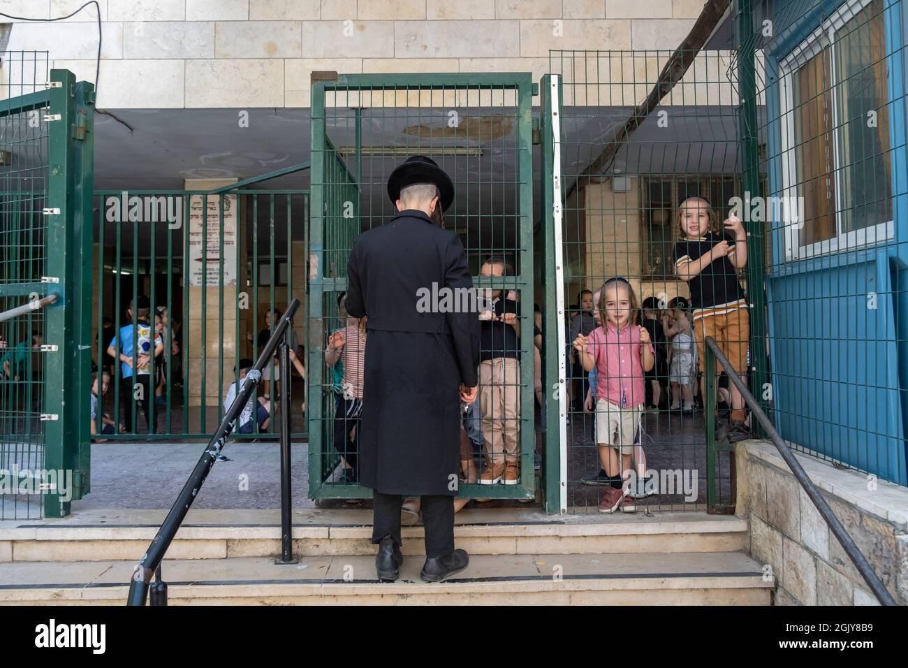 An Ultra Orthodox man enters children a primary school in the religious ...