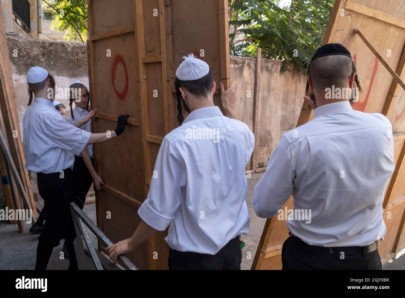 Orthodox Jews of the Toldos Aharon sect building a wooden sukkah or ...