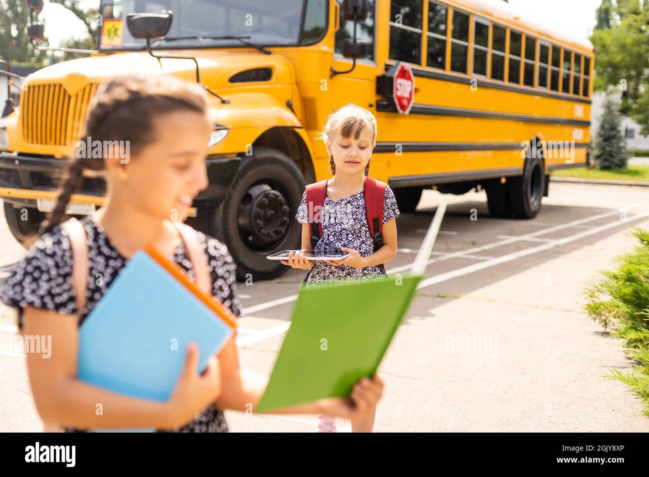 Education: Smiling Student Friends Ready For School next to school bus ...