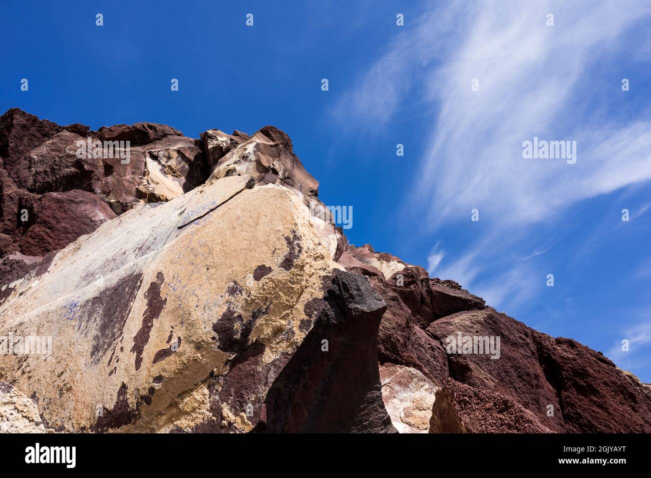 Huge red and yellow rock cliff on red sand beach Santorini. Alien ...
