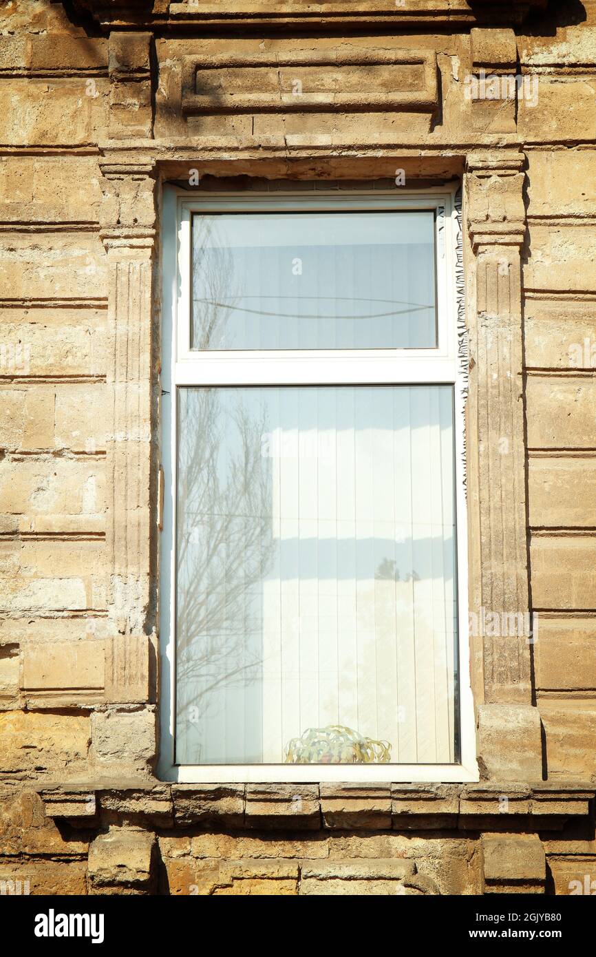 Vintage building with modern white plastic window Stock Photo - Alamy