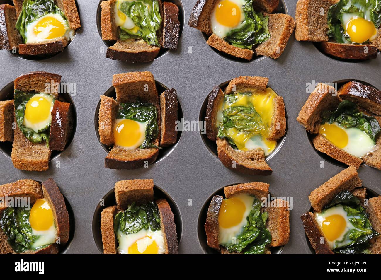 Baking mold with eggs and spinach, closeup Stock Photo - Alamy