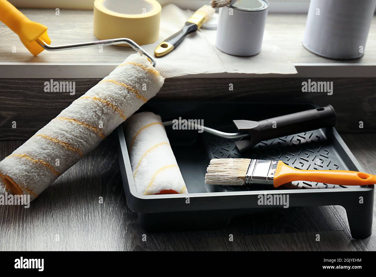 Set of tools for painting on window sill Stock Photo - Alamy