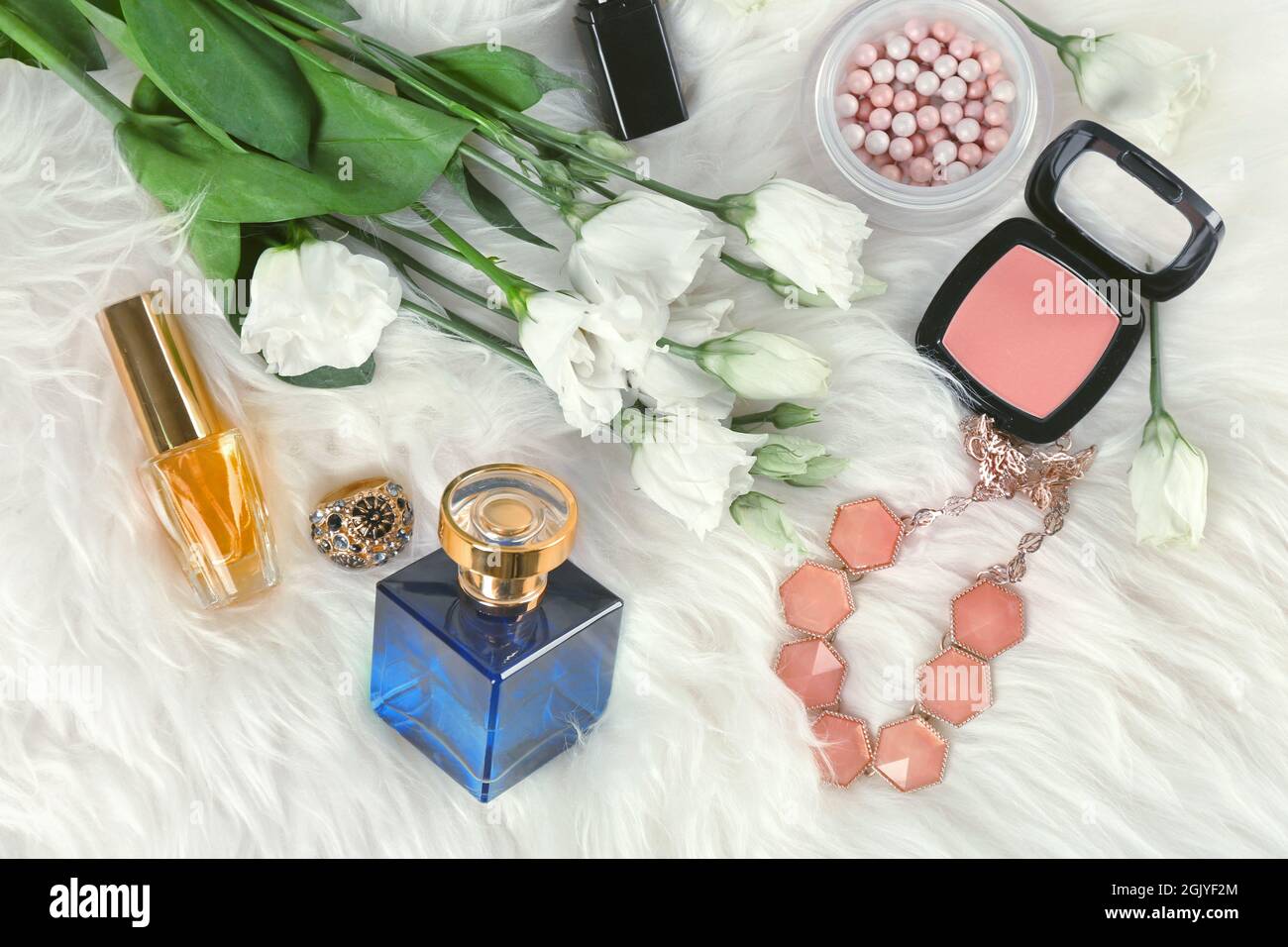 Beautiful composition with perfume bottle and flowers on furry ...
