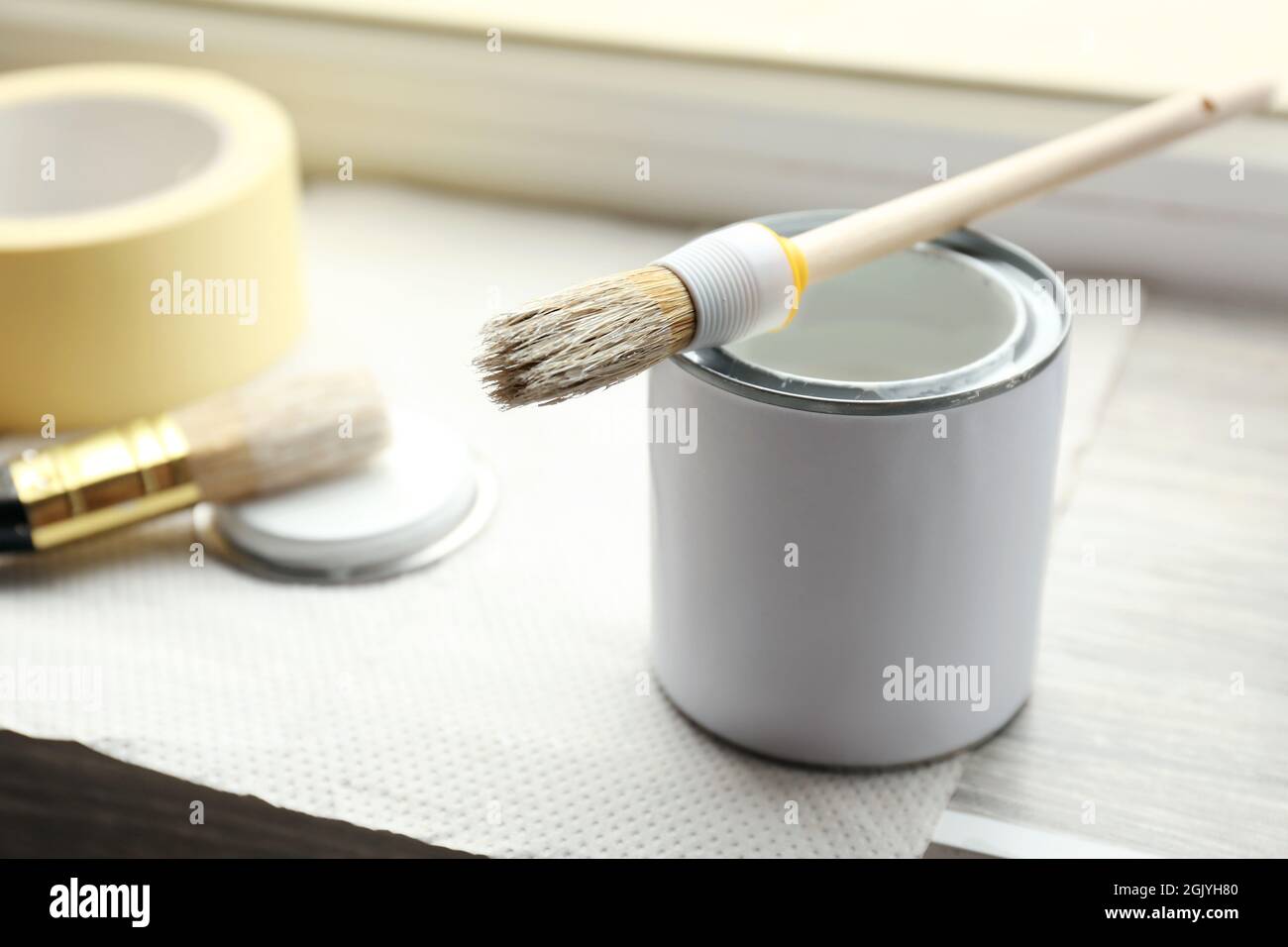 Can with paint and brush on window sill Stock Photo - Alamy