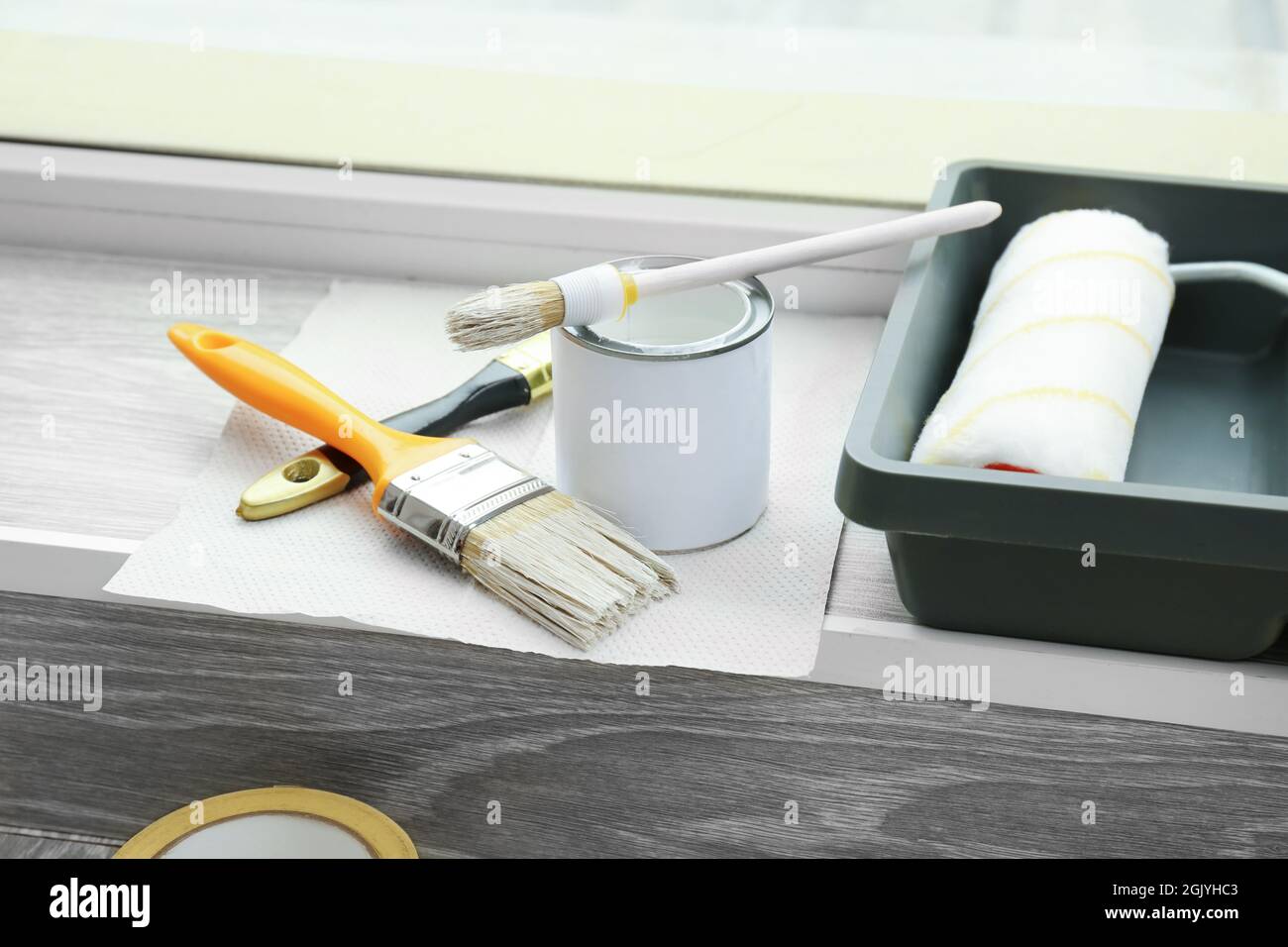 Set of tools for painting on window sill Stock Photo - Alamy