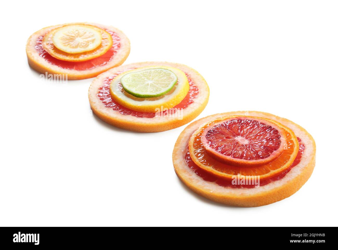 Citrus slices on white background Stock Photo - Alamy