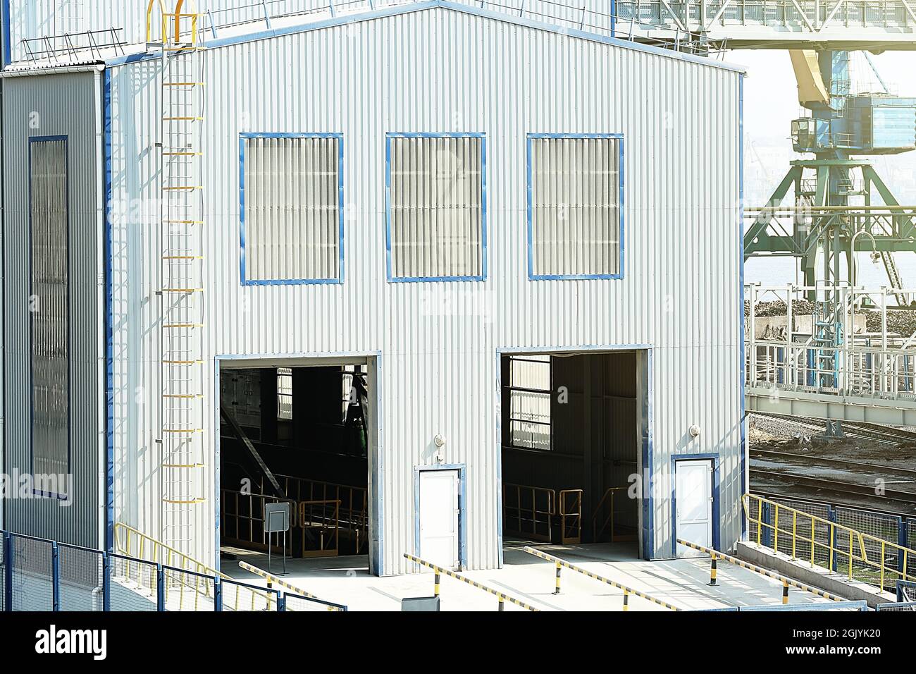 View of factory in sea port Stock Photo - Alamy