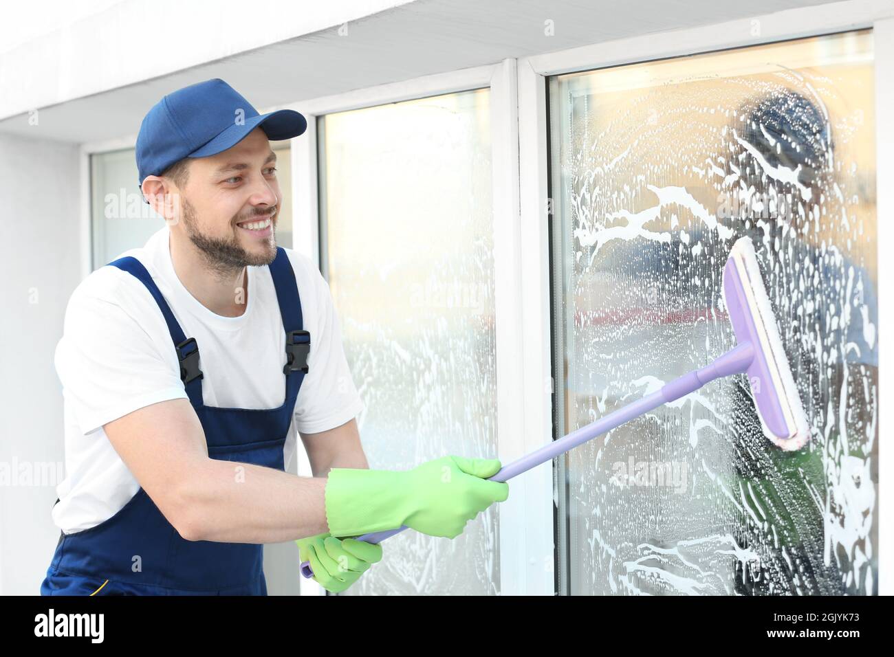 Young man washing window outdoors Stock Photo - Alamy