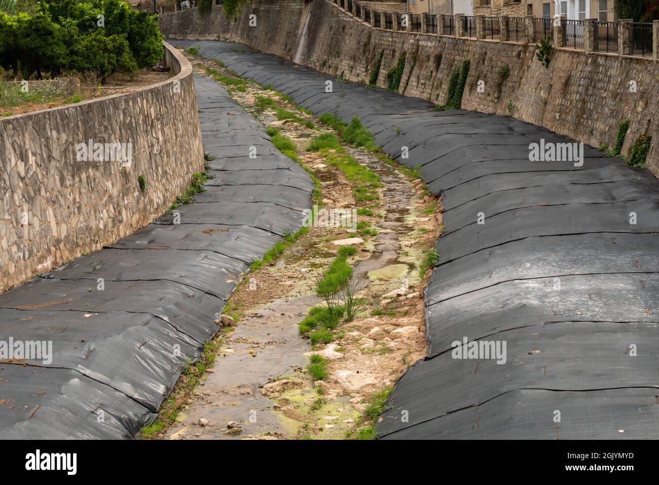 A view of an empty dried canal with an erosion protection system Stock ...