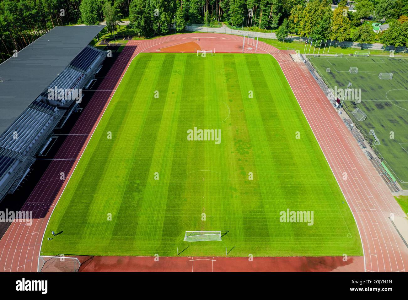 Aerial view of green football field. New public soccer stadium empty to ...