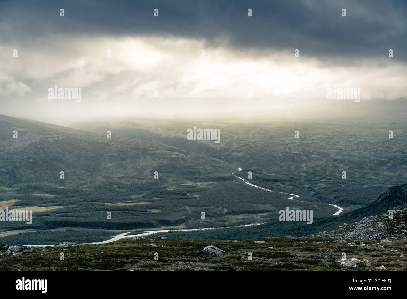 Bright sunlight comes through thick clouds and illuminates heavy ...