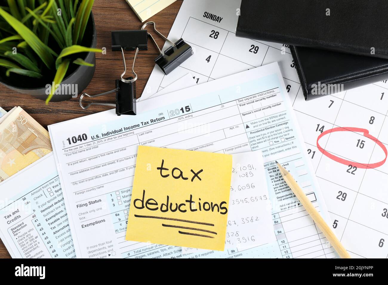 Paper sheet with text TAX DEDUCTIONS and individual tax return form on ...