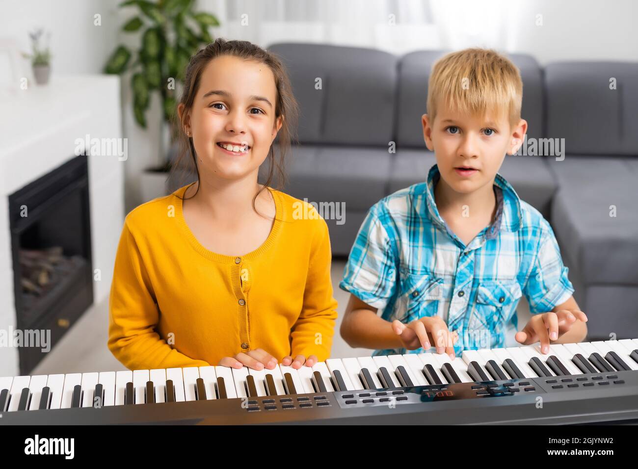 Brother and sister play the synthesizer. Children play at piano. family ...