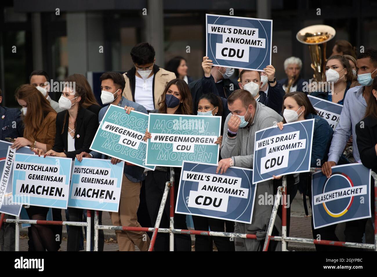 Berlin, Germany. 12th Sep, 2021. Fans of the CDU stand in front of a TV ...