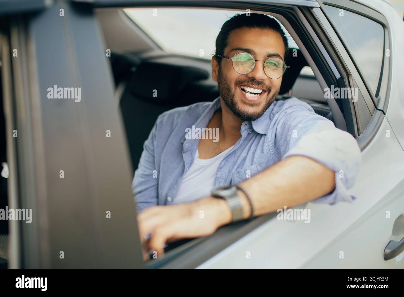 Cheerful arab guy passenger enjoying car ride Stock Photo - Alamy